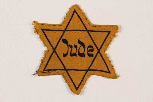 Yellow cloth Star of David badge with Jude printed in the center ...