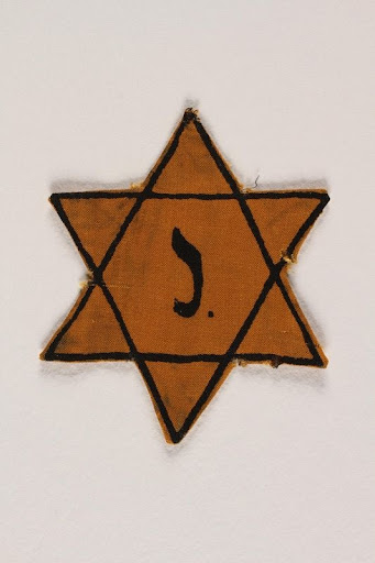 Yellow Star of David badge with the letter J worn by a young Belgian ...